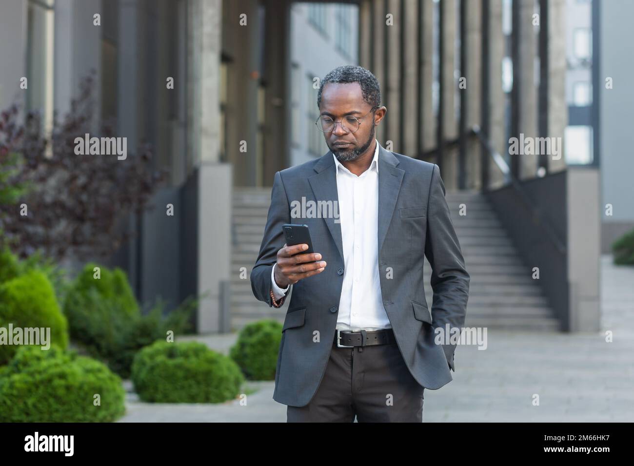 Serious and successful African American boss businessman outside office ...