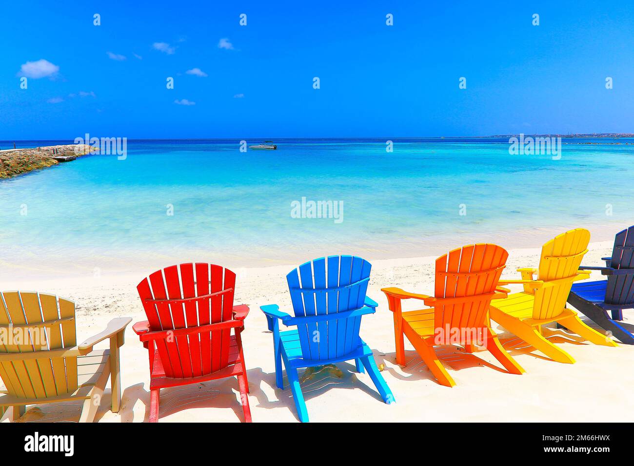 Colorful wooden chairs on white sand beach in Aruba, Duth Caribbean ...