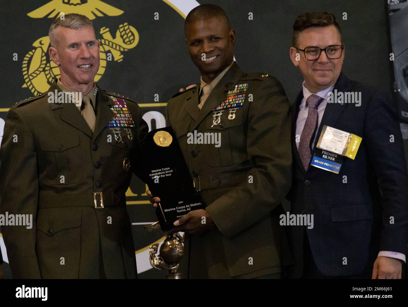 United States Marine Corps Maj. Orlando Higgins, accepts an award at ...