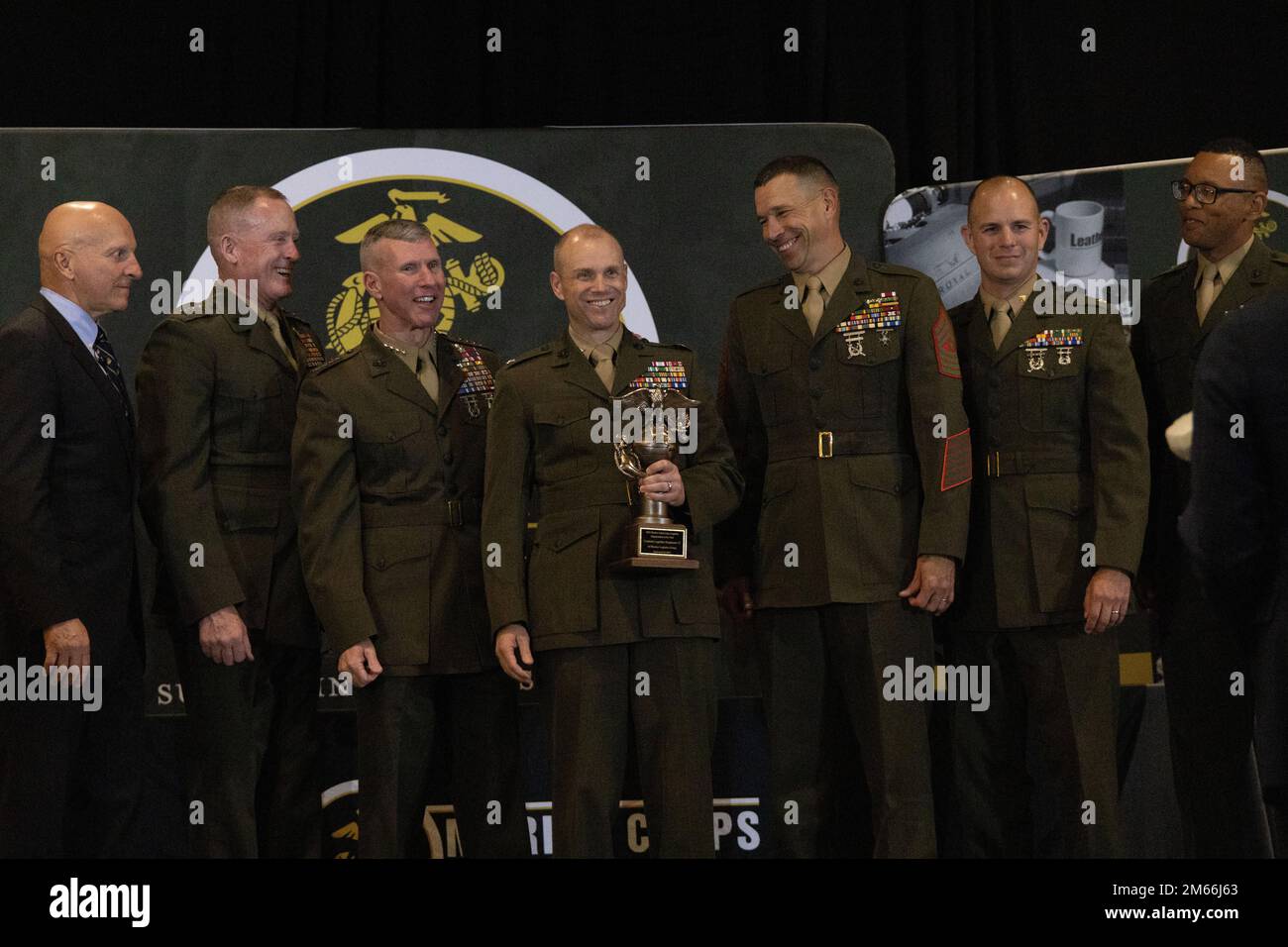 United States Marine Corps Col. Douglas Burke, accepts an award at the ...