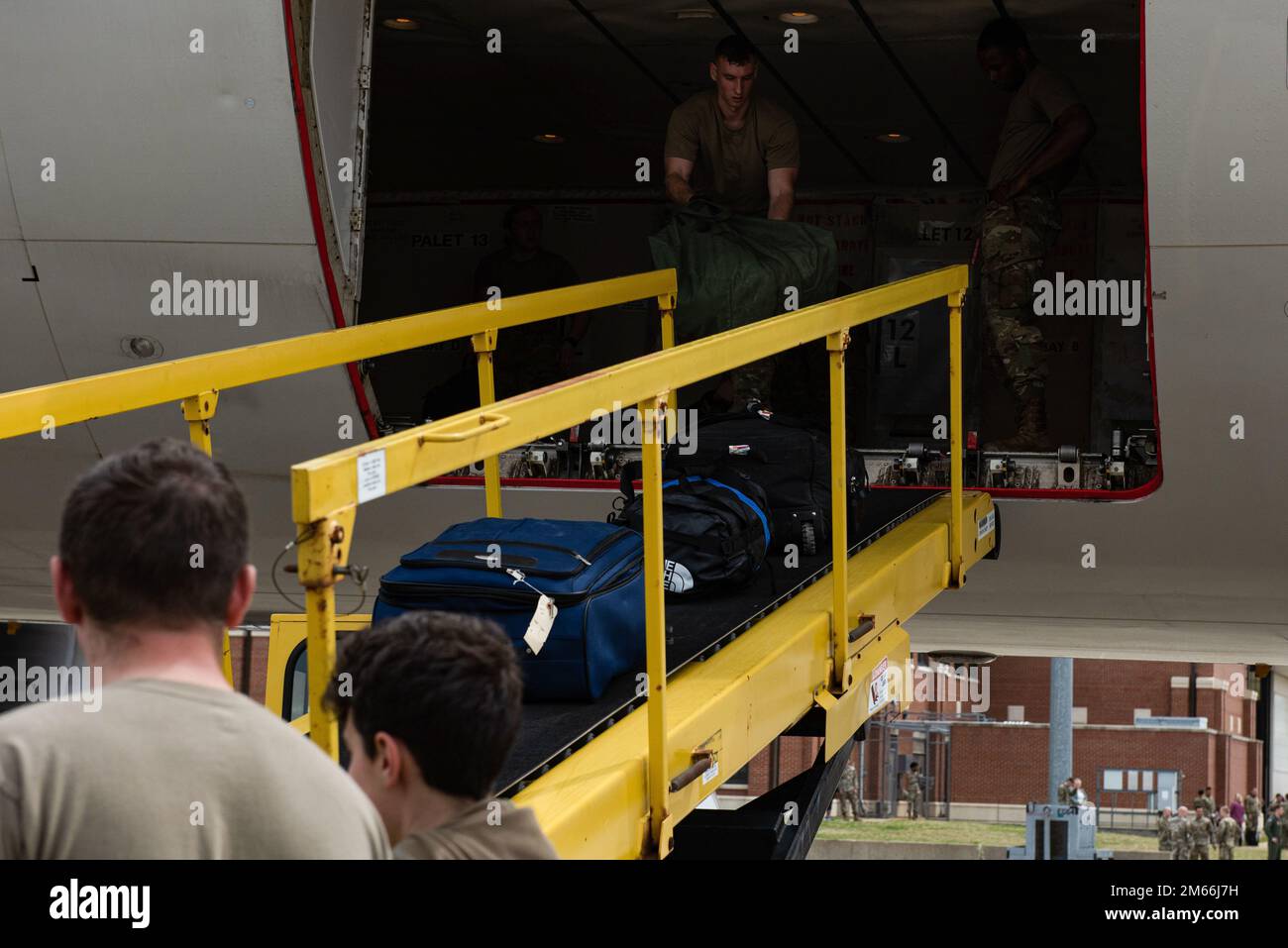 U.S. Airmen unload a plane upon arrival from the UAE at Joint Base ...