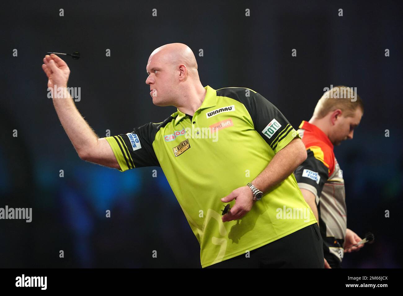 Michael van Gerwen in action against Dimitri Van den Bergh during day fifteen of the Cazoo World ...