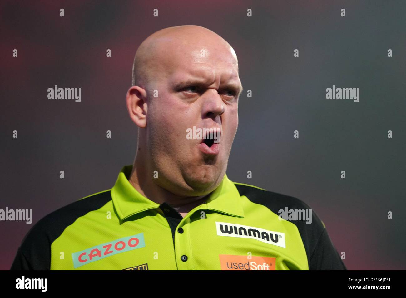 Michael van Gerwen in action against Dimitri Van den Bergh during day fifteen of the Cazoo World ...