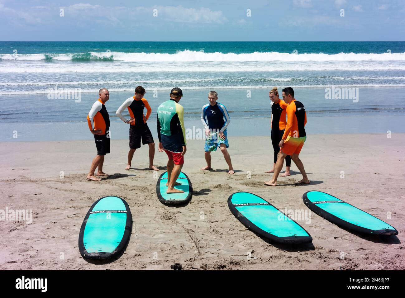 Tourists have a surfing lesson Stock Photo - Alamy