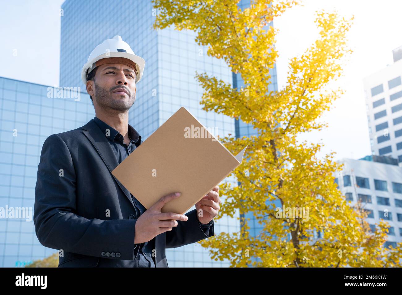 Experienced architect, constructor engineer in protective white helmet ...