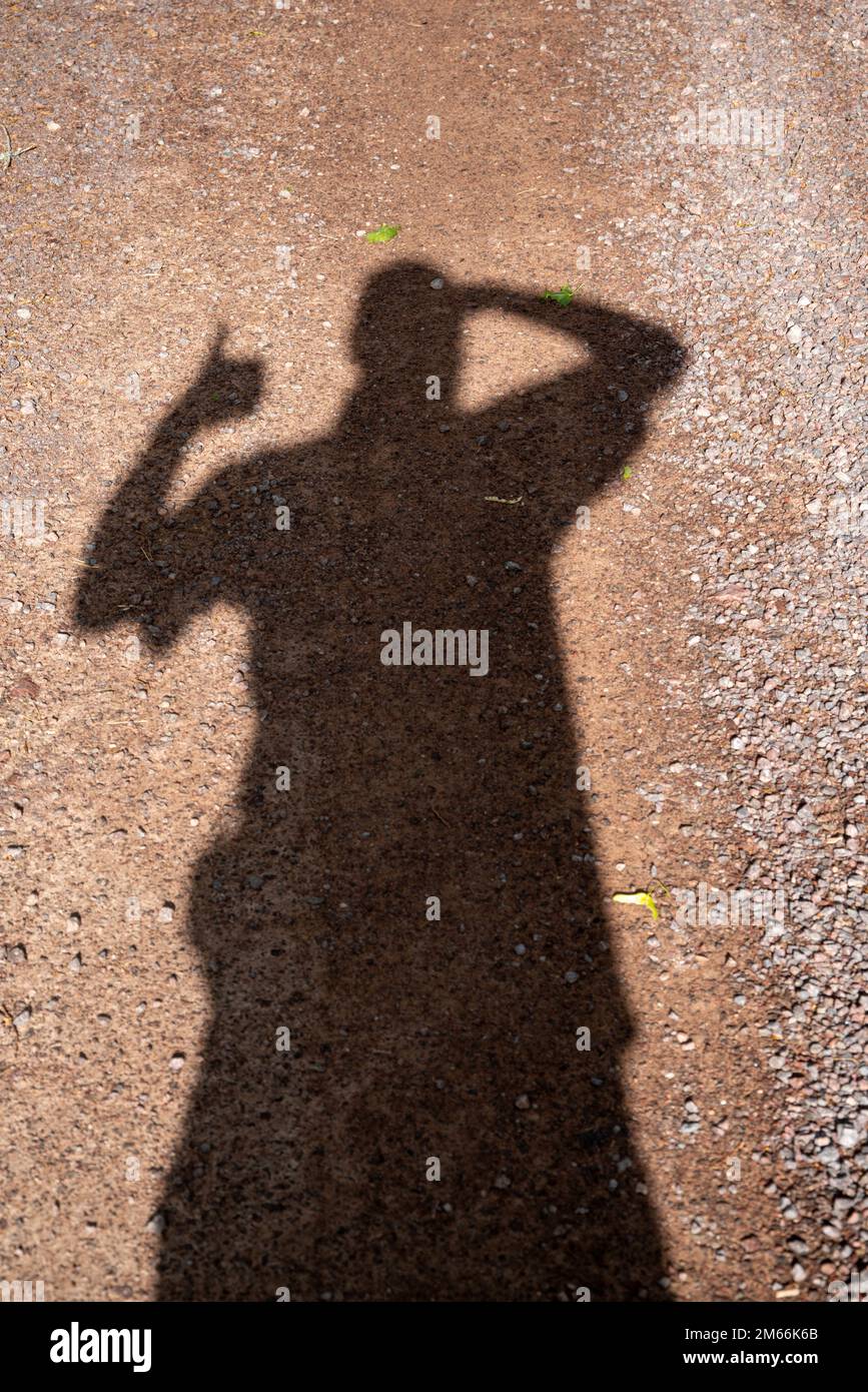 Shadow of a man looking into the distance and showing thumb up Stock ...