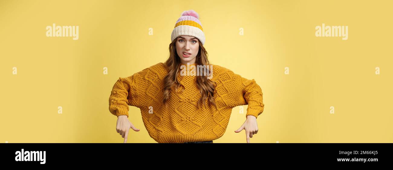 Arrogant snobbish displeased picky girl customer pointing down cringing ...