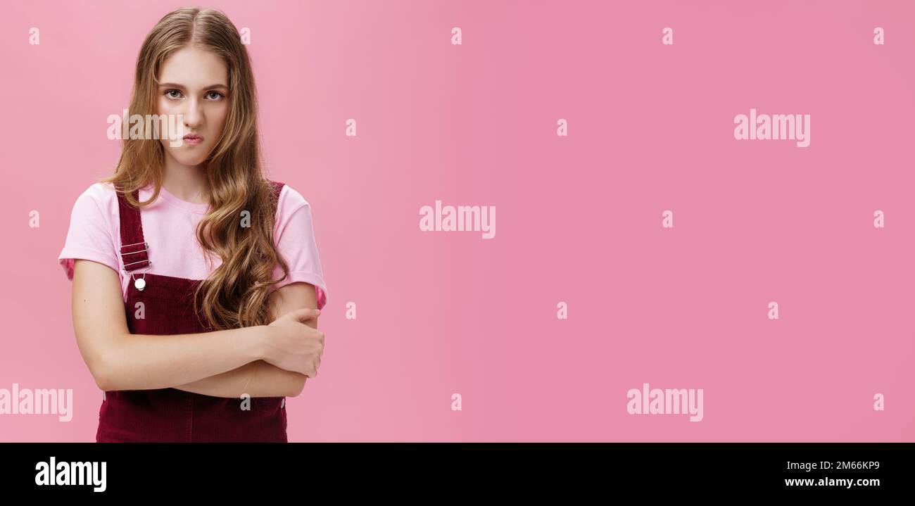 I mad on world. Unhappy hateful young arrogant girl in overalls with ...