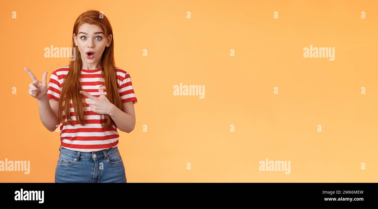 Wow awesome. Impressed excited beautiful redhead woman look astonished ...