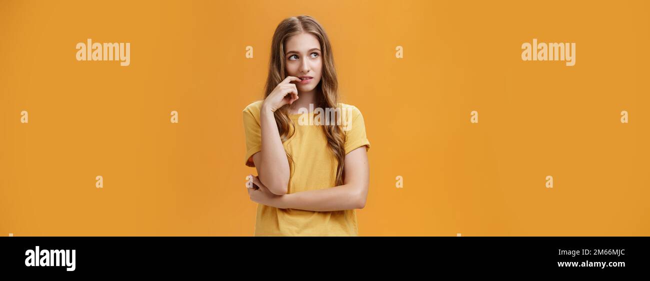 Dreamy and focused attractive young common slender girl with wavy ...