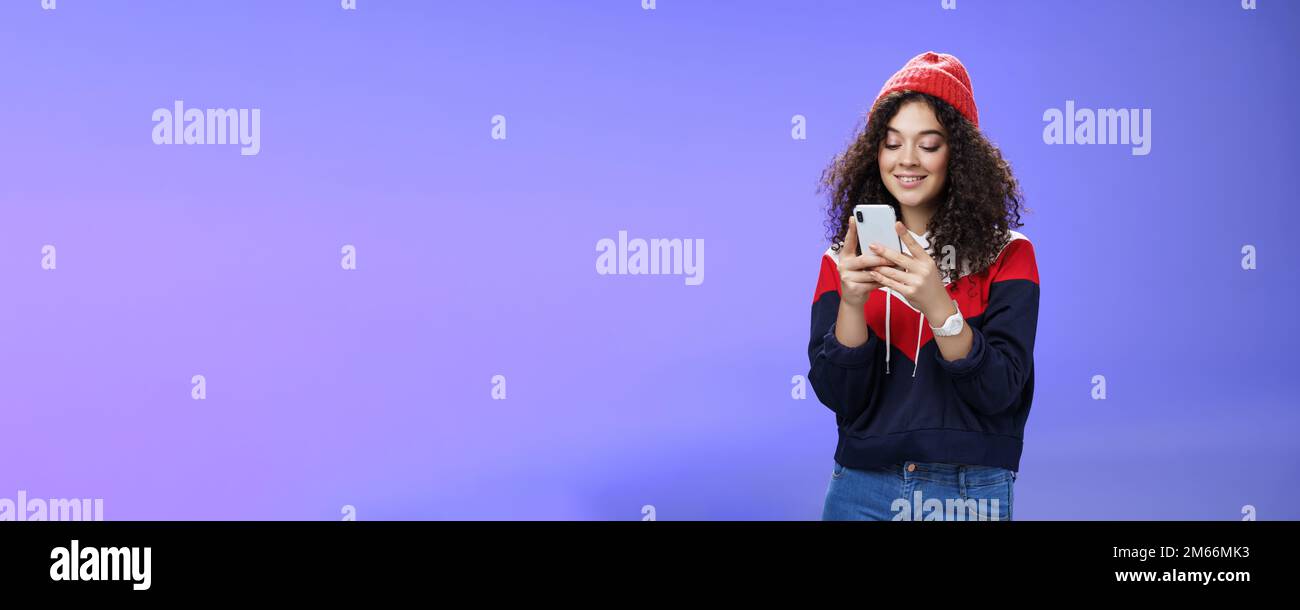 Woman searching in internet funny memes, holding mobile phone in hands ...