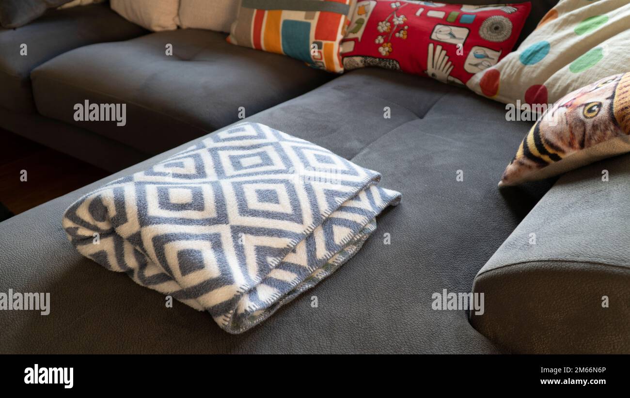 Cozy couch blanket with pillows in a modern living room setting ...