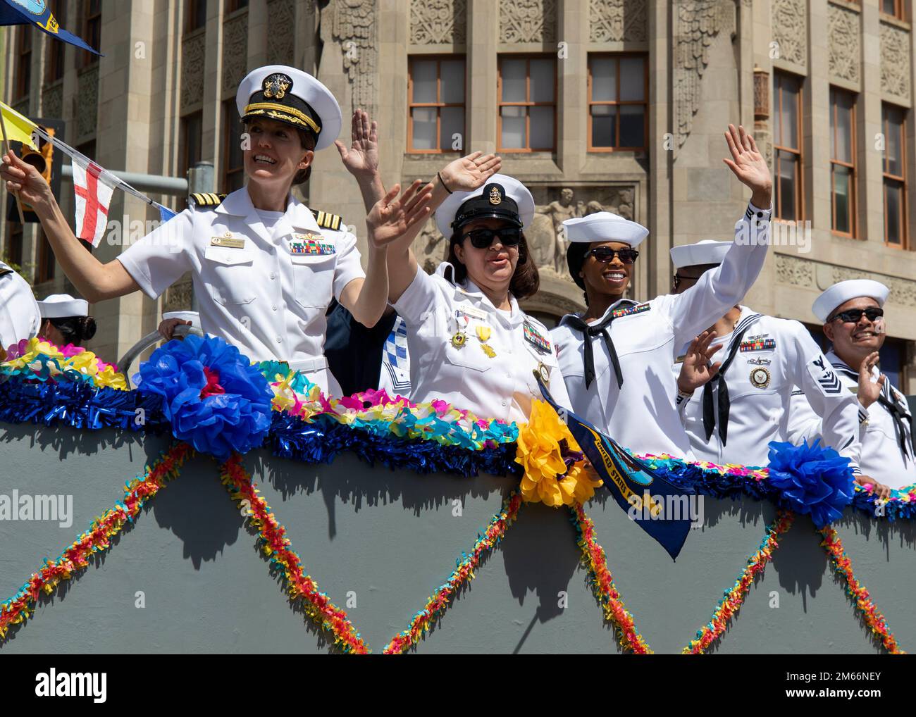 U.S. Navy senior leaders wave from a float in the Battle of the Flowers ...