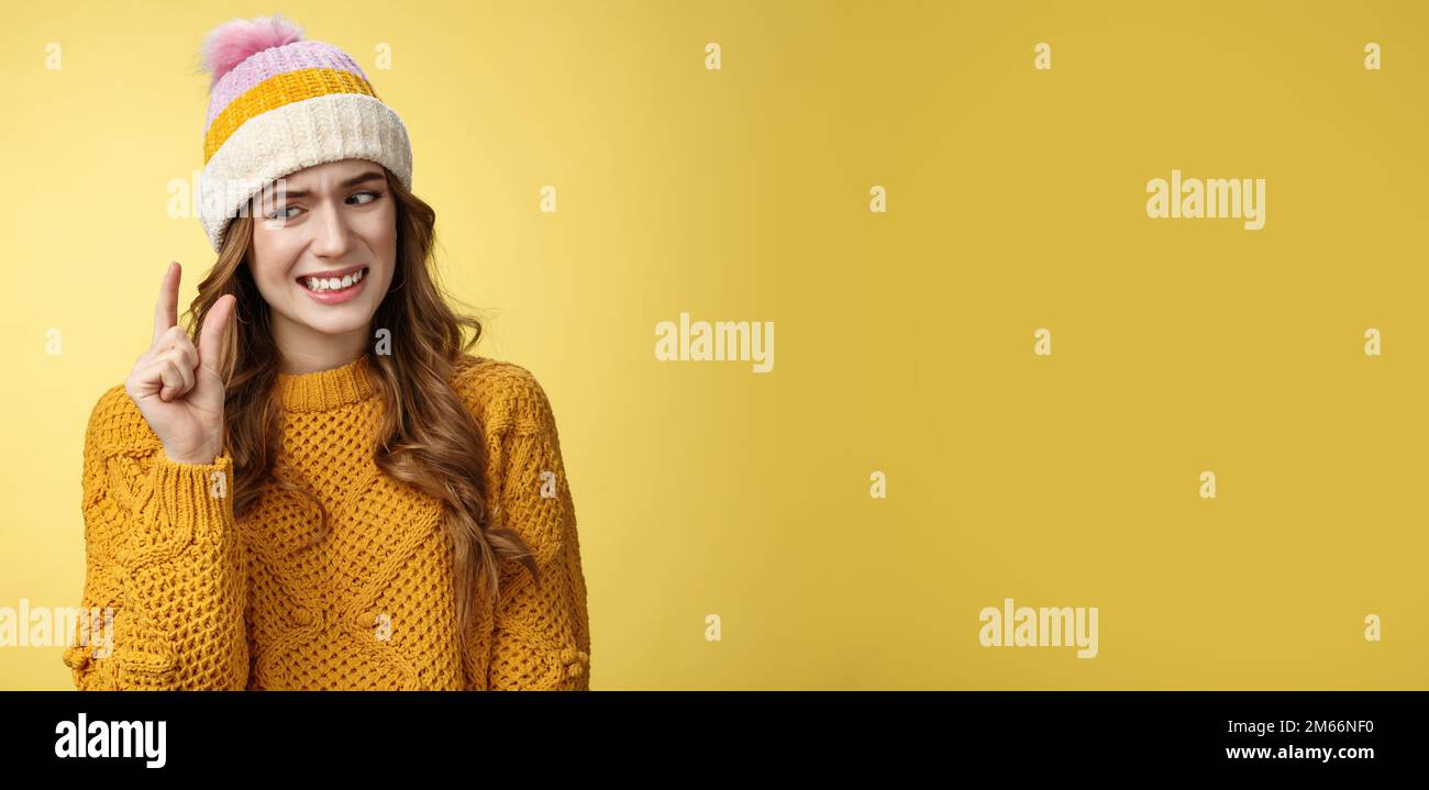 Displeased attractive picky woman describing small object show tiny ...