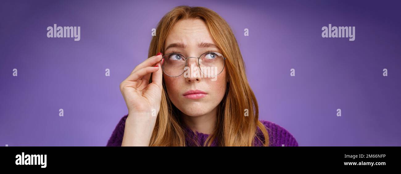Clumsy and cute young female teacher in glasses with red hair looking ...
