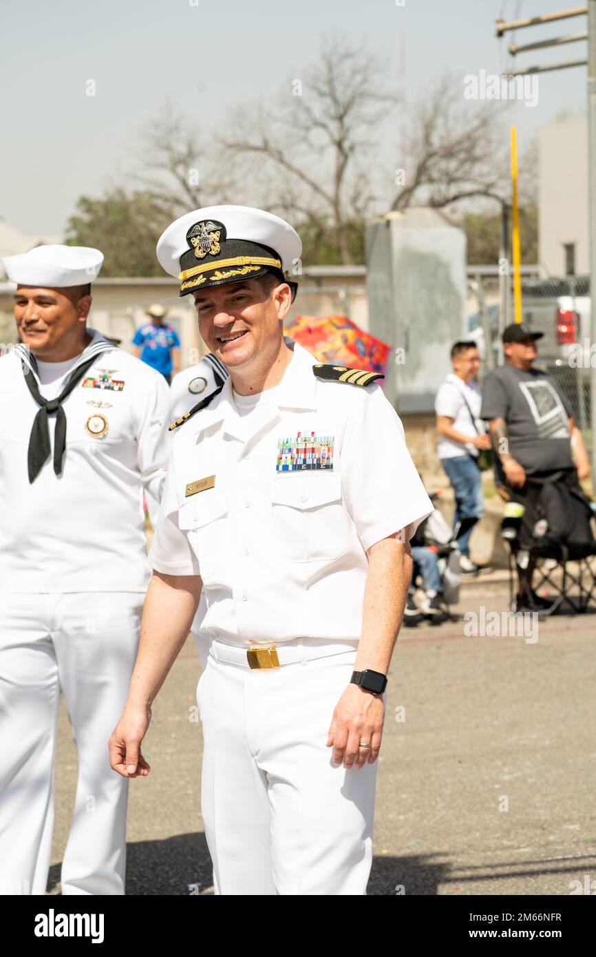 A U.S. Navy Sailor walks through the Battle of Flowers Parade in San ...