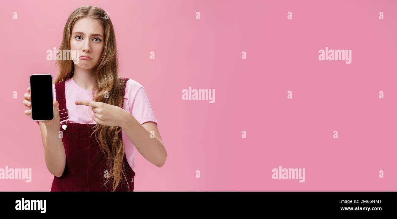 Sad gloomy young female with cute wavy natural hairstyle showing ...