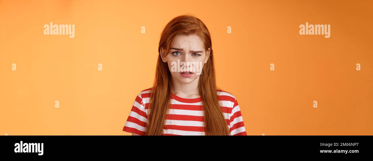 Close-up stupified puzzled redhead perplexed woman, open mouth raise ...