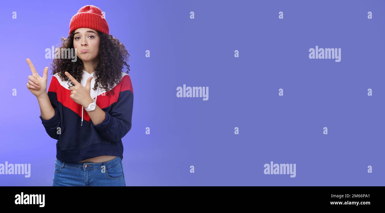 Portrait of silly upset cute curly-haired woman in trendy beanie ...