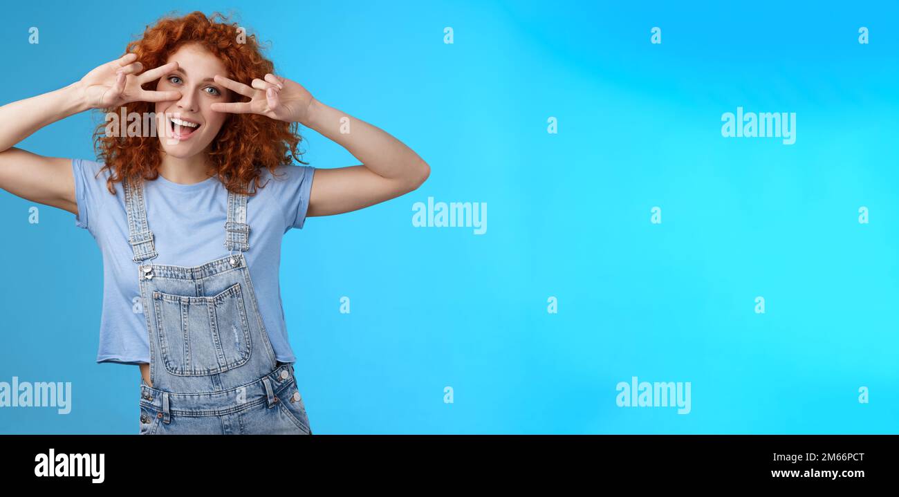 Cheerful cute redhead ginger girl curly haircut show positivity peace ...