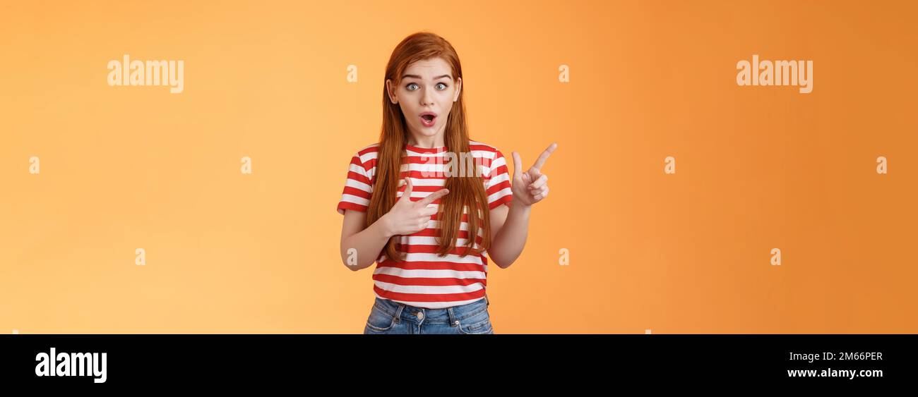 Wow awesome. Impressed excited beautiful redhead woman look astonished ...