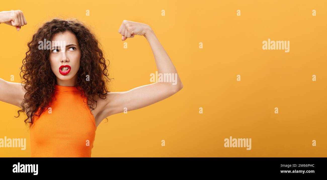 Woman showing biceps feeling muscles hi-res stock photography and ...