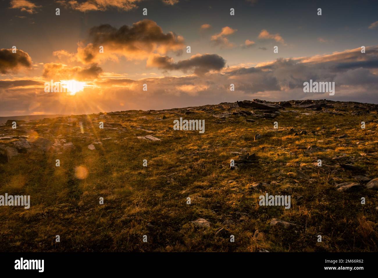 Midnight sun rising over Knivskjellodden, a trail in the tundra towards ...