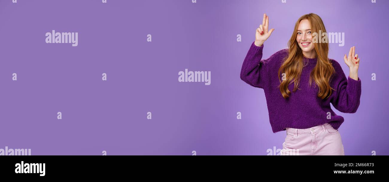 Girl in happy and energized mood dancing having fun making finger ...