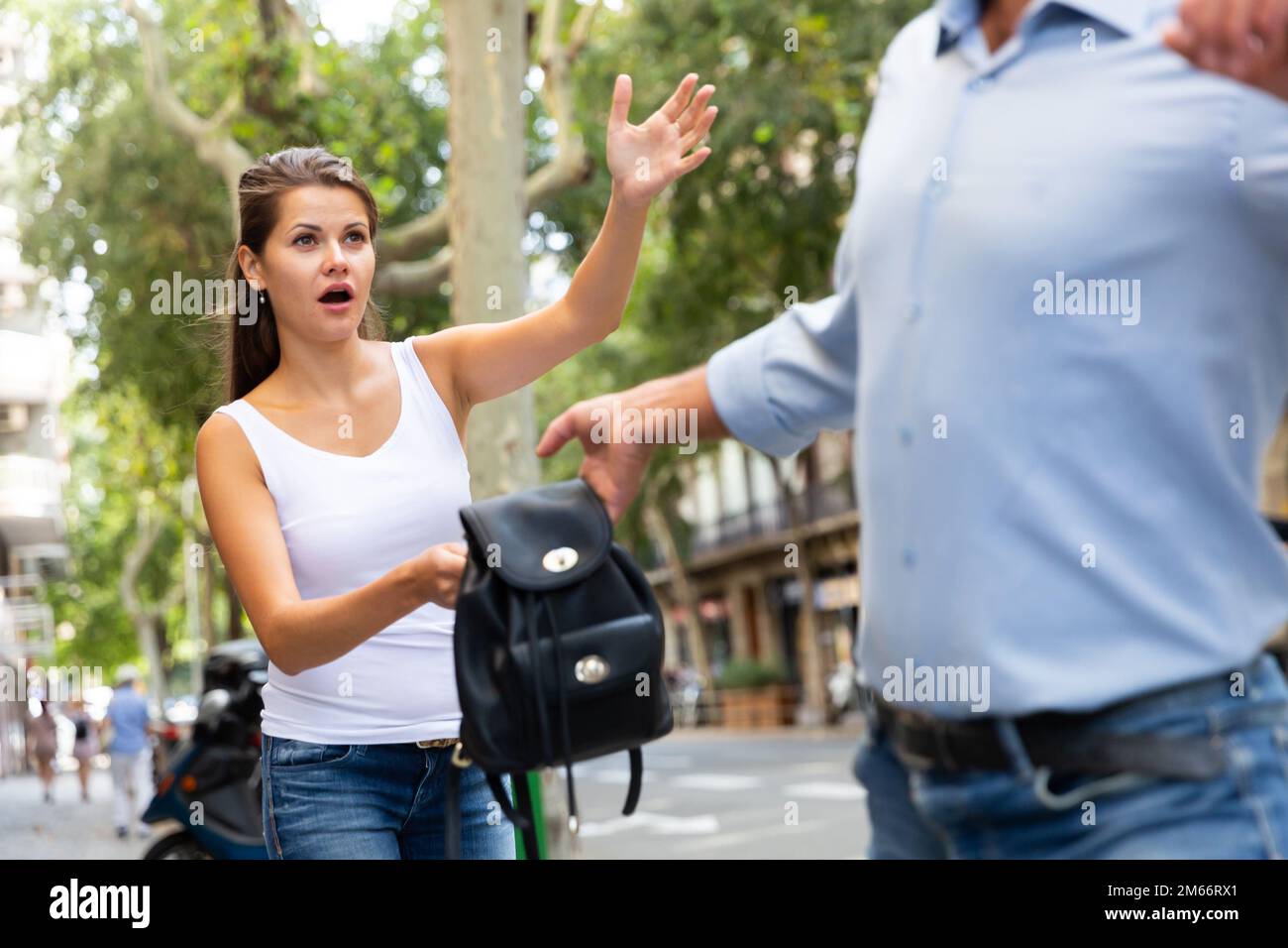 Street robbery pulling woman backpack Stock Photo - Alamy