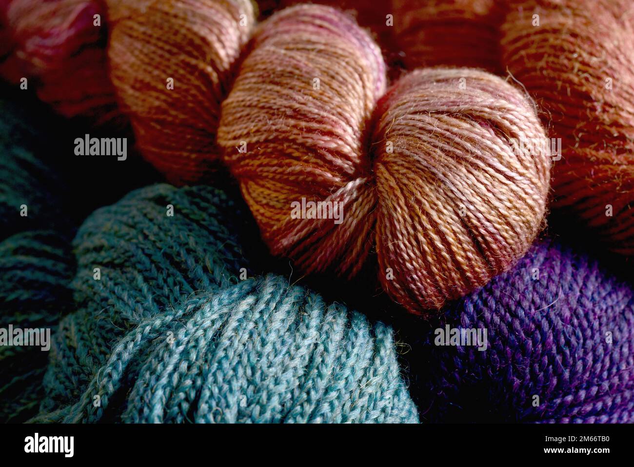 Skeins of rainbow, purple and green silk and merino yarns Stock Photo ...