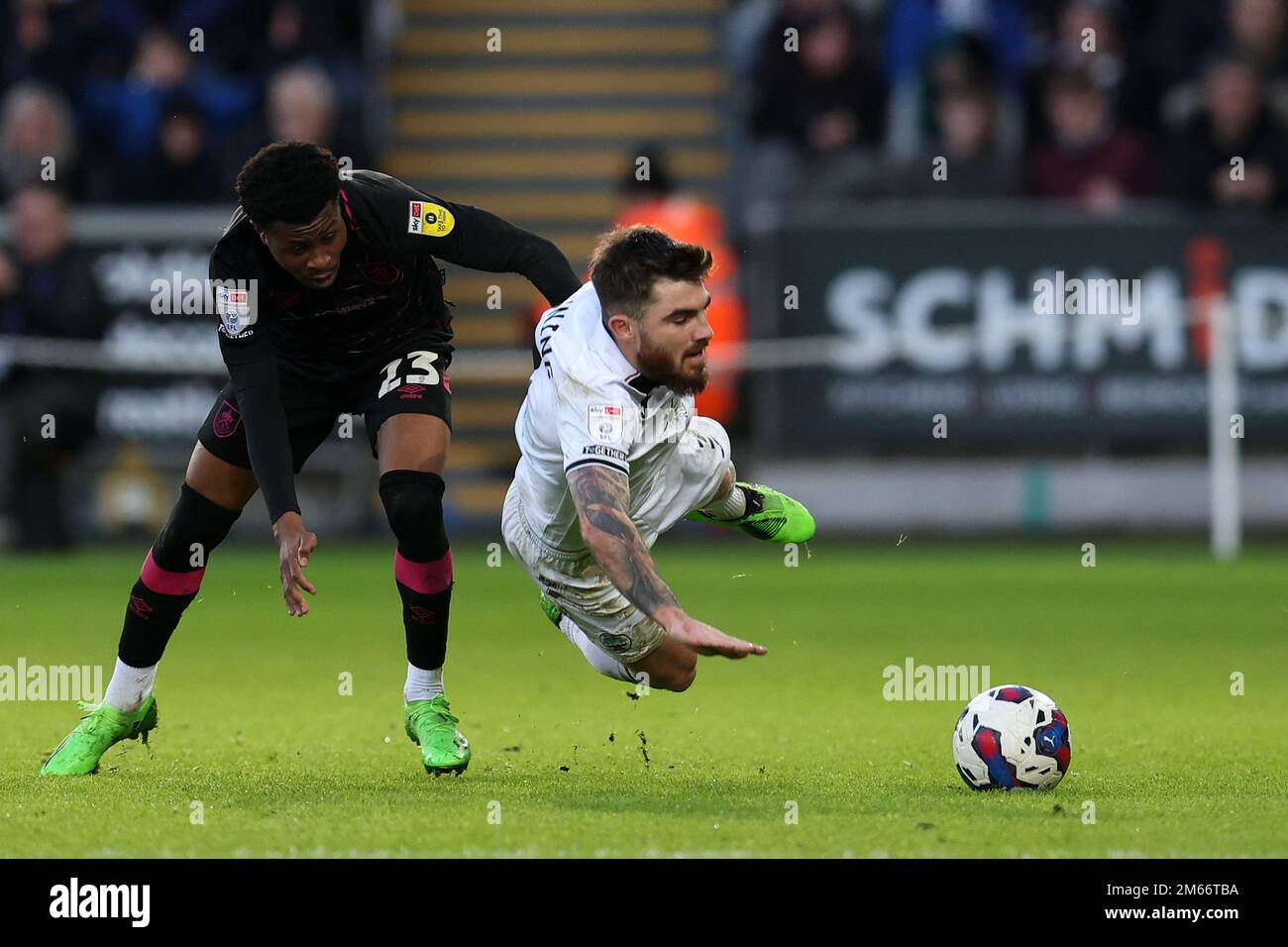 Swansea, UK. 02nd Jan, 2023. Ryan Manning of Swansea City (r) is fouled ...