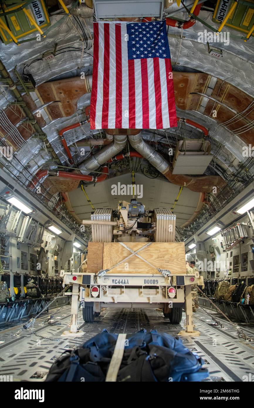 An American flag hangs from a C-17 Globemaster III assigned to the ...