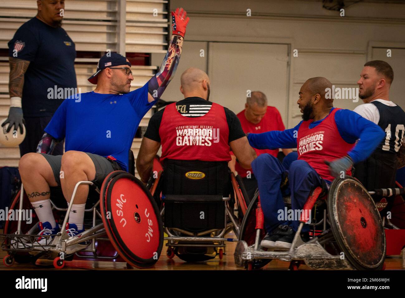 Team U.S. athletes, grabs the ball at the wheelchair rugby practice ...