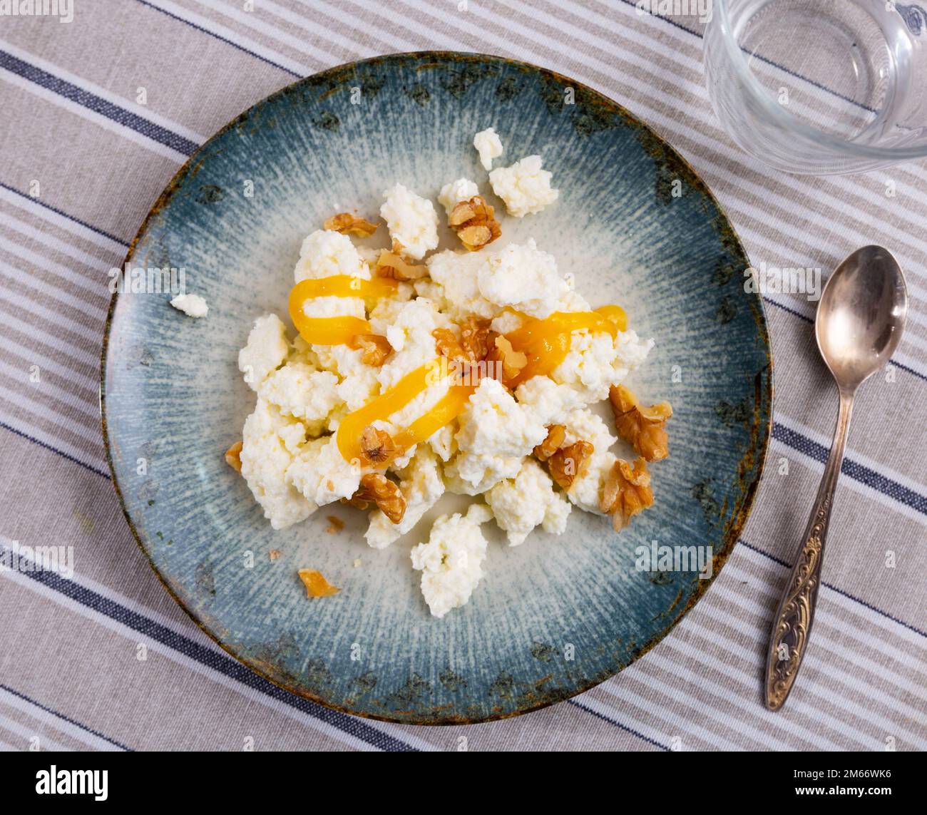 Fresh cottage cheese with honey and walnuts Stock Photo - Alamy