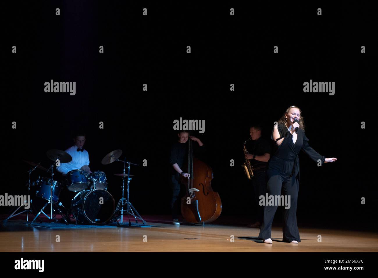 U.S. Coast Guard Academy cadets perform a song as a band at the Coast ...