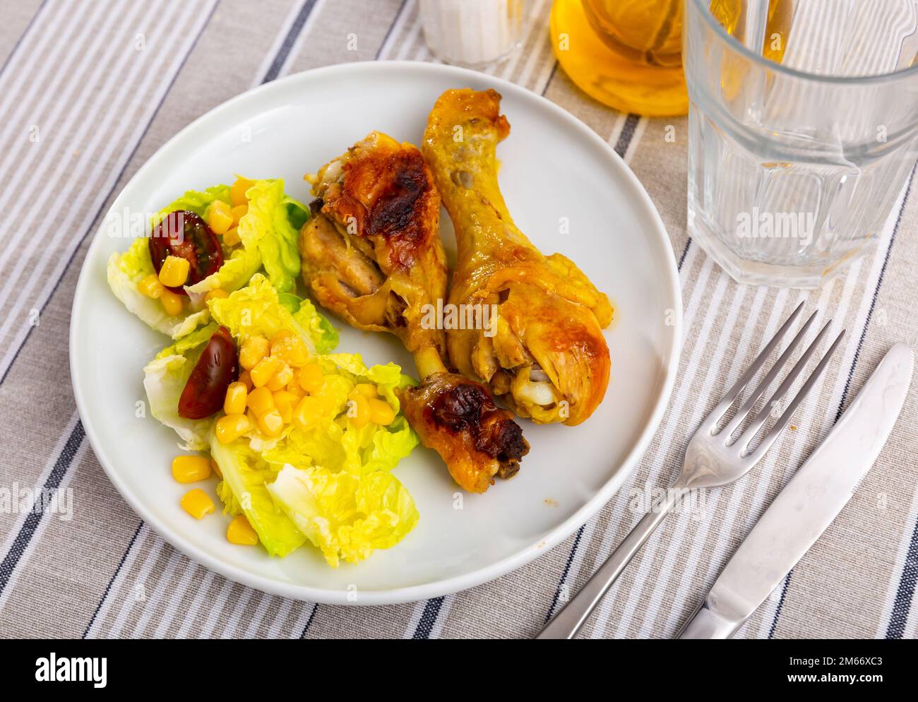 Appetizing chicken leg with salad Stock Photo - Alamy