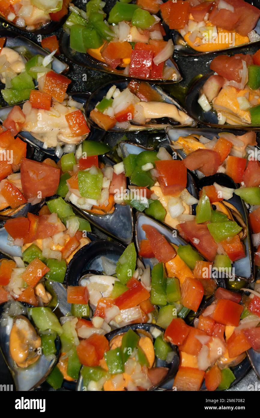 cooked mussels stuffed with red and green peppers and vinegar sauce ...