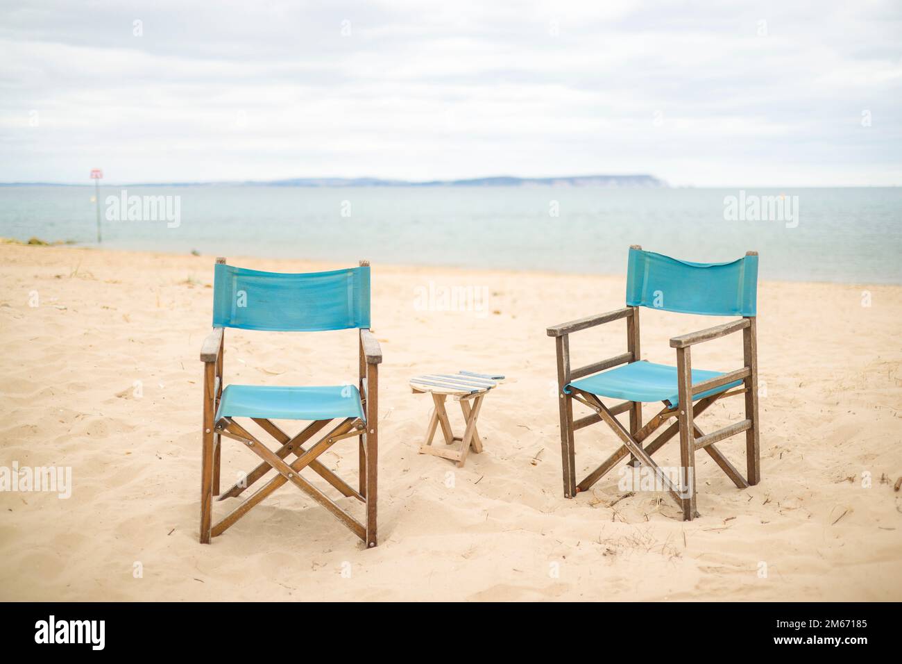 Directors chairs on a beach on Dorset Coast. UK summer seaside scene ...