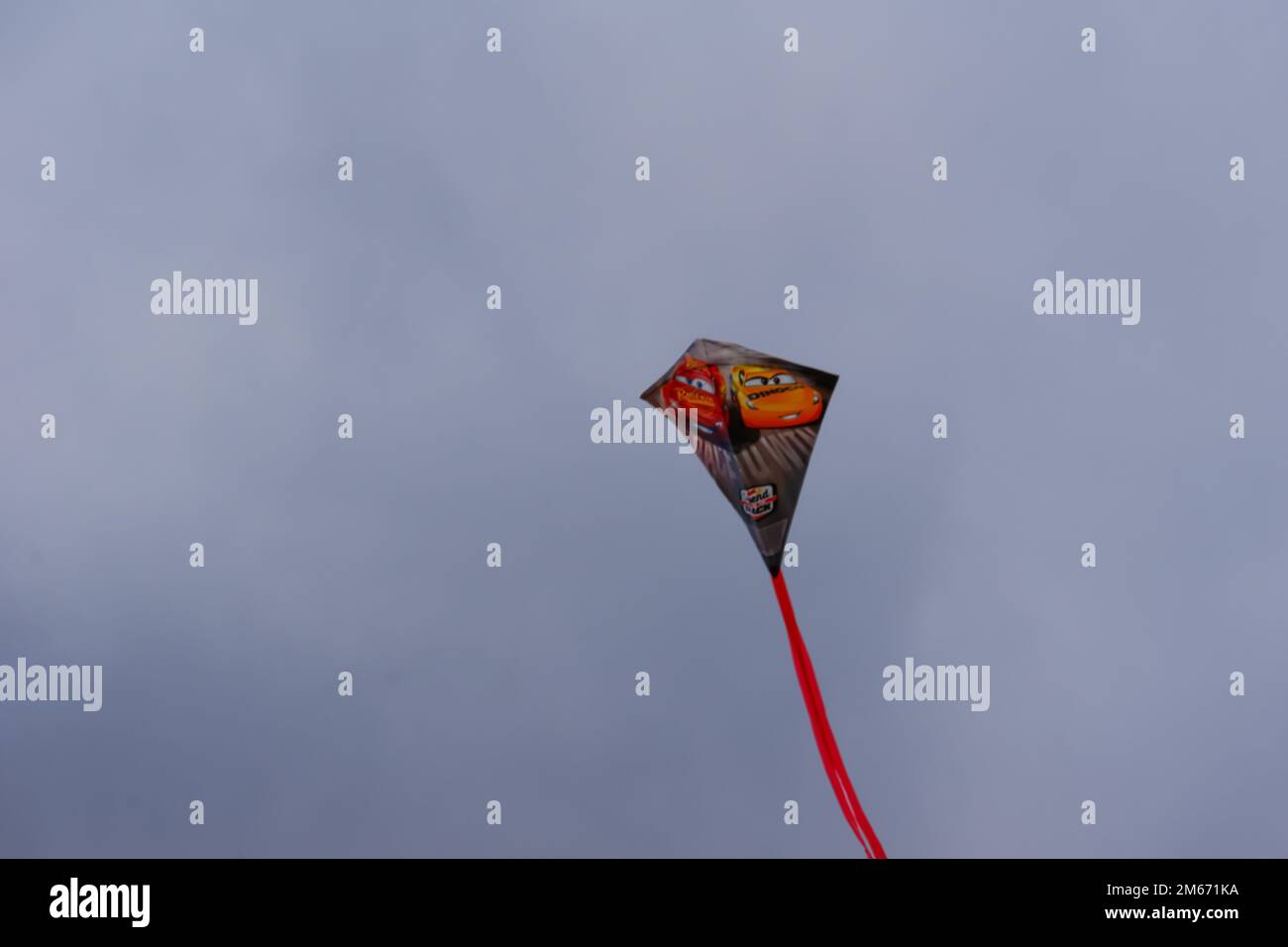 Kite with cars on it at dark cloudy sky Stock Photo - Alamy