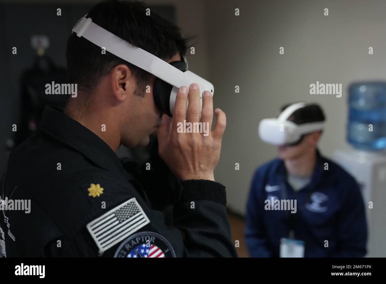 U.S. Air Force Maj. Joshua “Cabo” Gunderson (left), pilot for the F-22 ...
