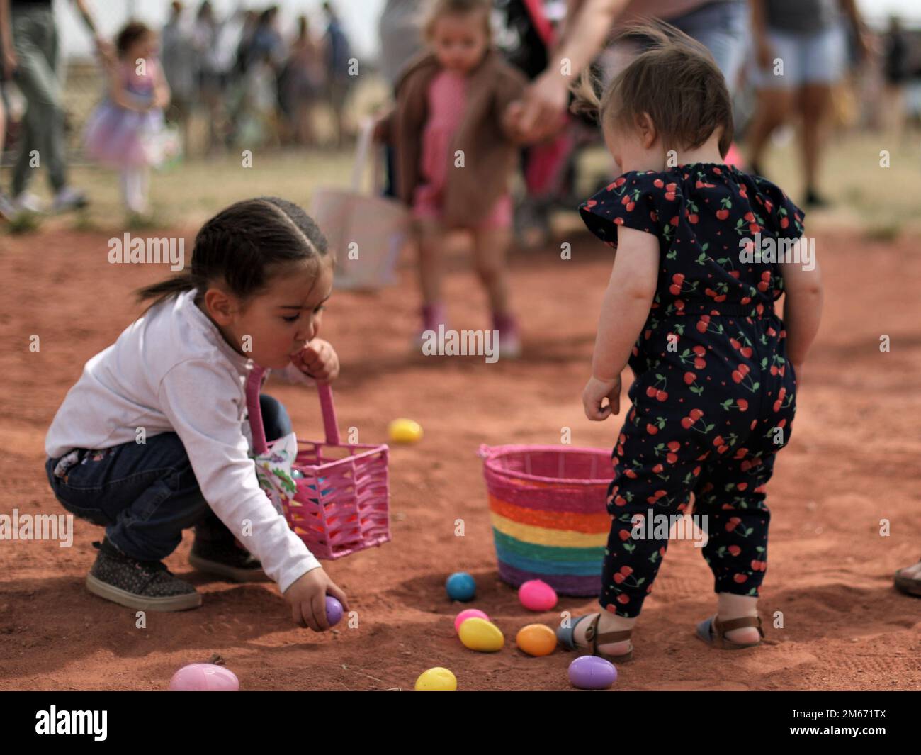 Children collect Easter eggs during an Easter Egg Hunt event hosted by ...
