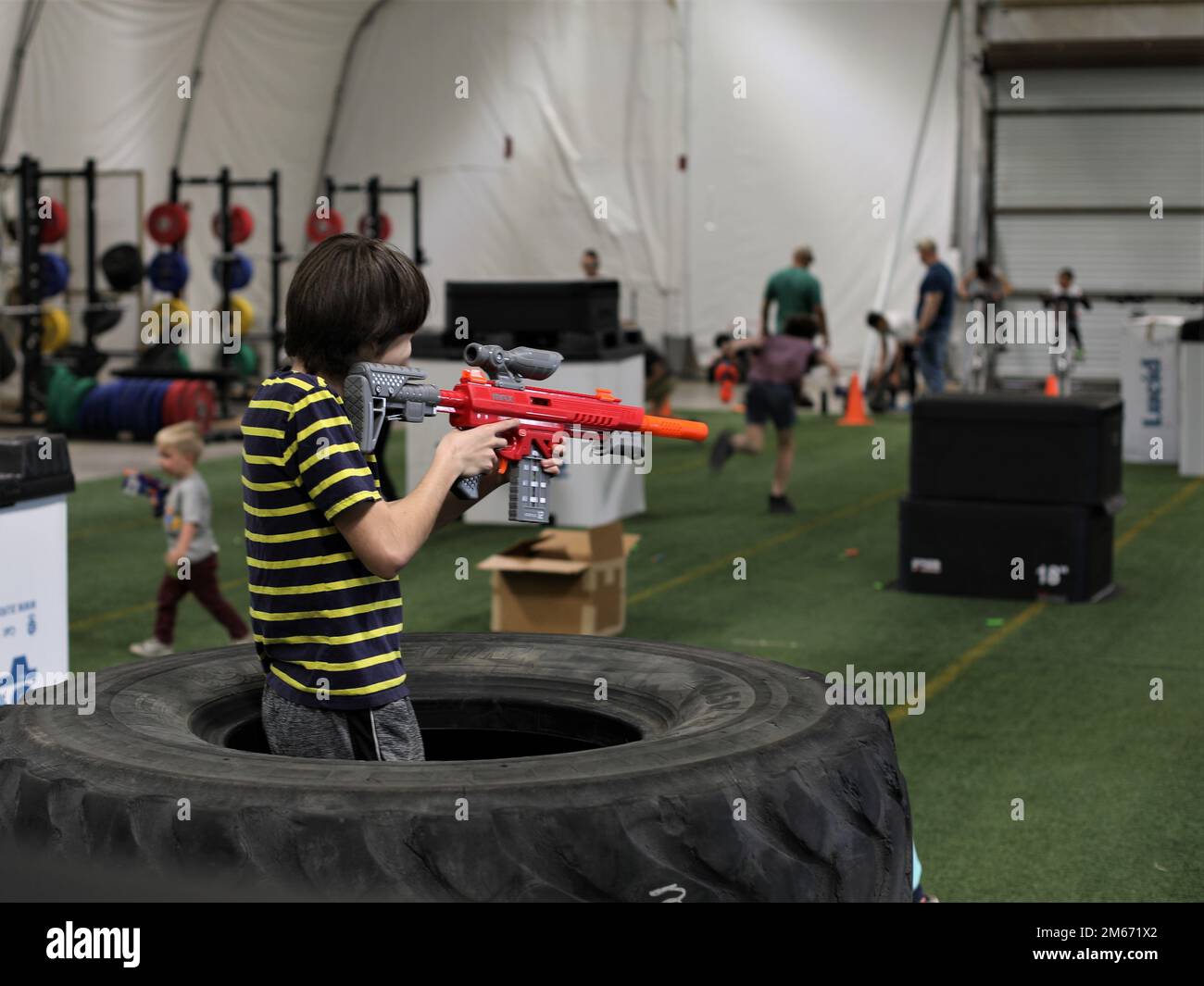 A child fires a foam dart rifle during an Easter Egg Hunt event hosted ...