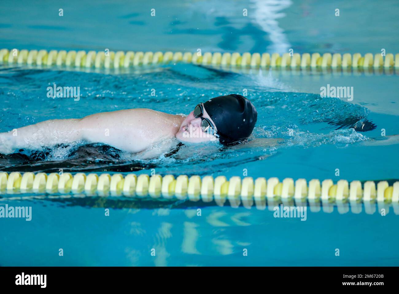 Retired U.S. Marine Corps Beth Grauer does some laps in the pool during ...