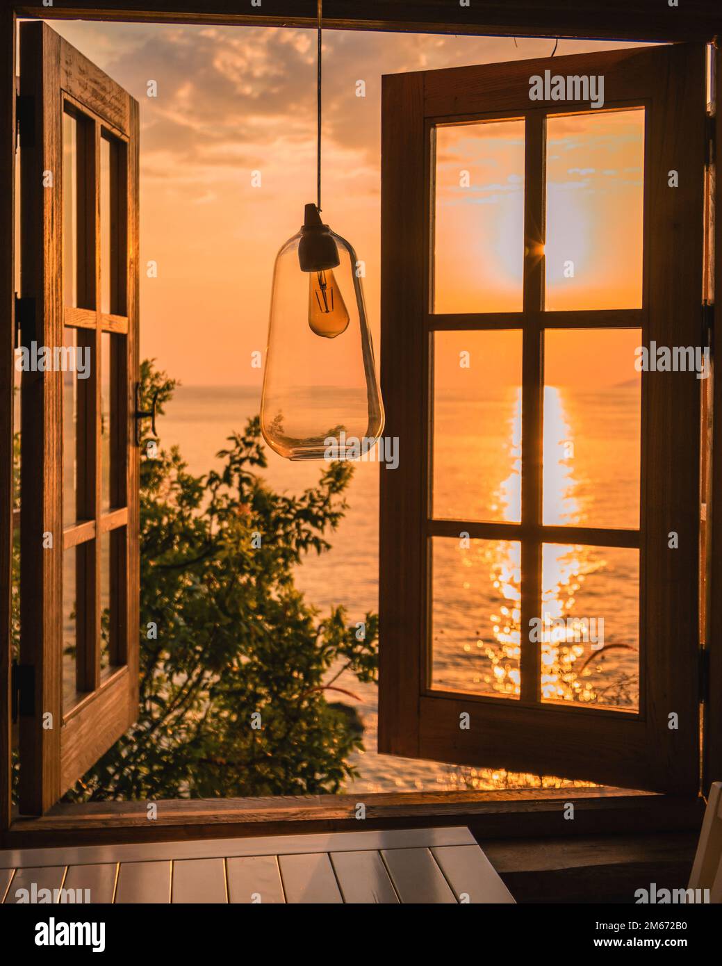 Turkey, Fethiye sunset by the beach through a window with a view at the ...