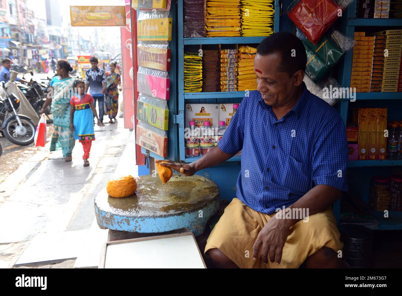 A vendor selling oils, perfumes and sandalwood paste in their shop in ...