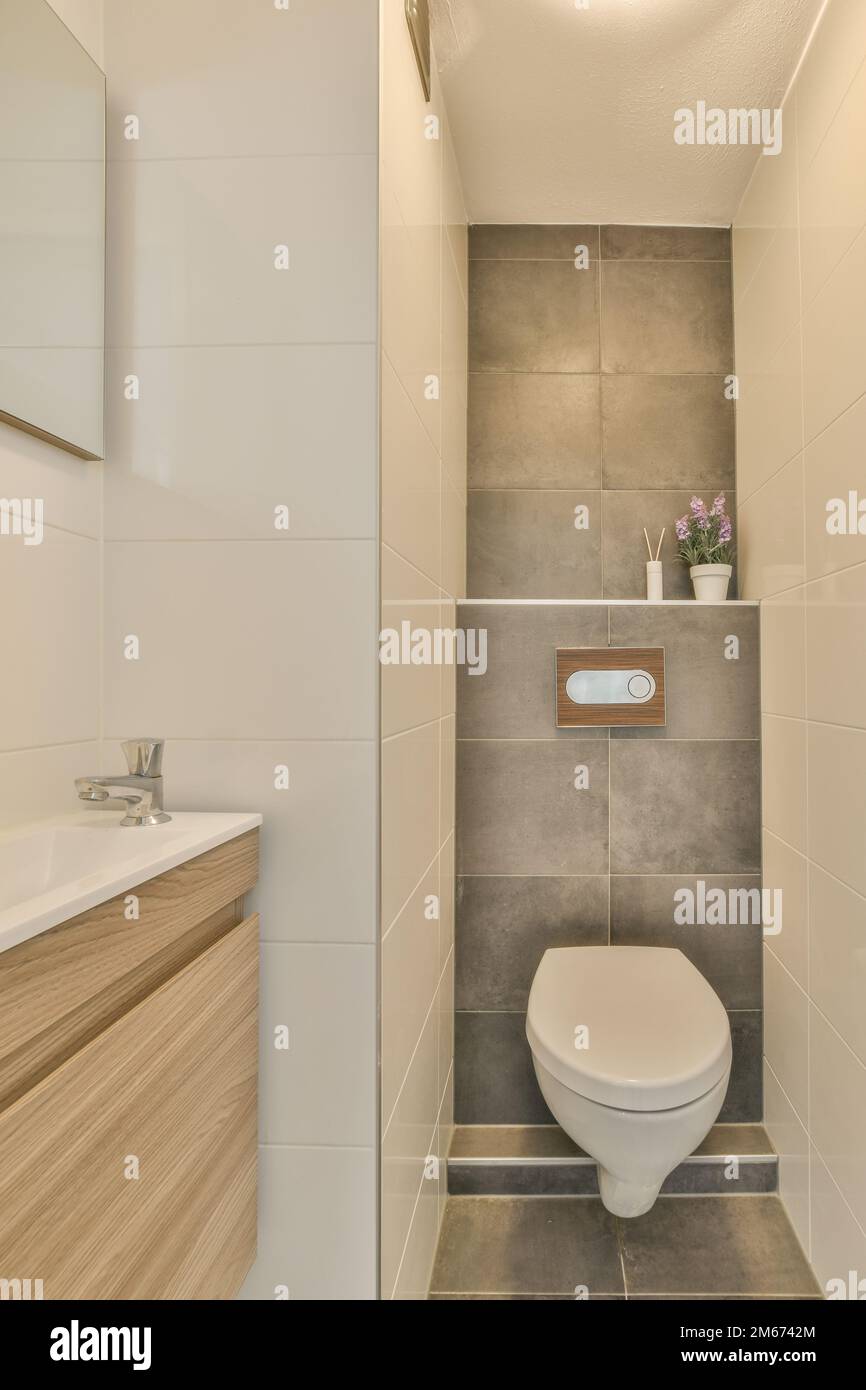 a bathroom with a toilet in the corner and a sink on the other side ...