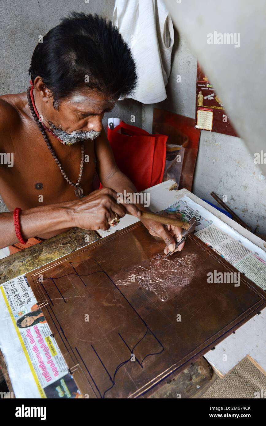 A craftsman working in his workshop in the grounds of the Meenakshi ...