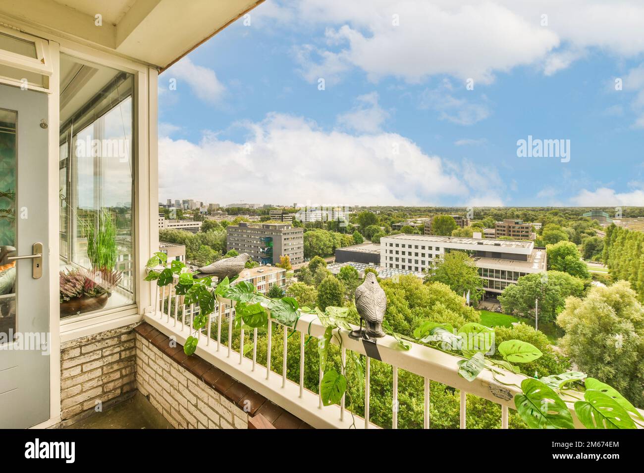 a balcony with trees and buildings in the background, as seen from an ...