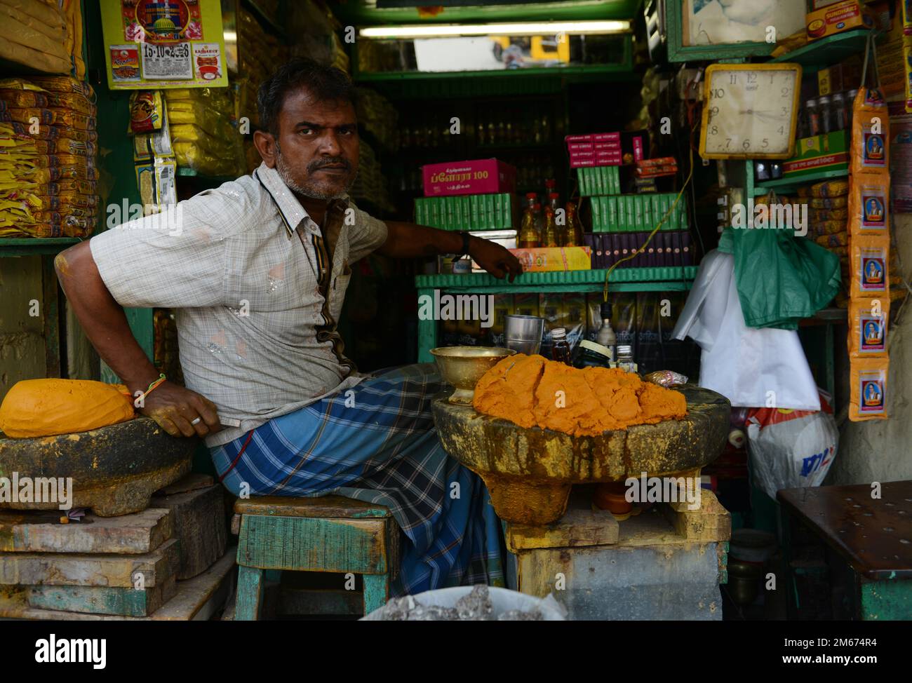A Dealer of sandalwood paste in their shop in Madurai, Tamil Nadu ...