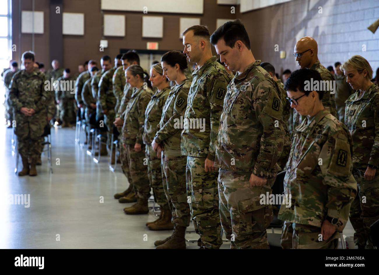 Soldiers bow their heads during the invocation at a ceremony for Army ...
